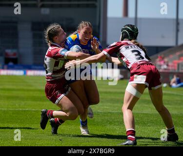 Caitlin Beevers of Leeds Rhinos drives into the Wigan Warriors defence ...