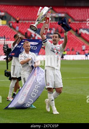 Crawley Town's Dion Conroy celebrates on the pitch with the trophy ...