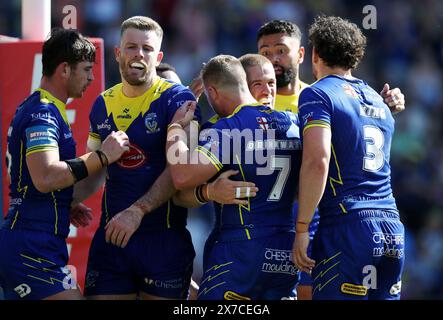 Warrington Wolves' Matt Dufty (right) is tackled by St Helens' Moses ...