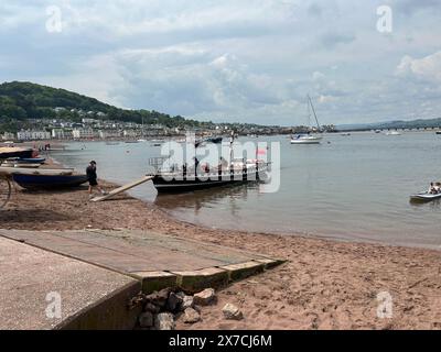 People board the Teignmouth-Shaldon ferry after it arrived on the beach ...