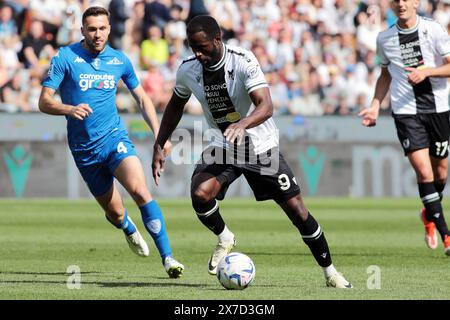 Udinese's Keinan Davis in action hindered by Lazio's Reda Belahyane ...