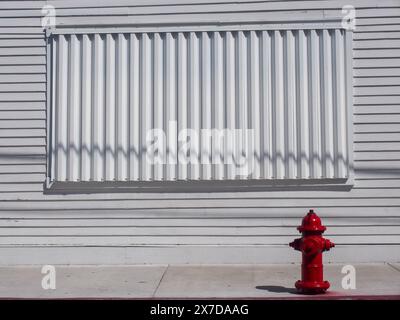 Red fire hydrant and white hurricane shutters, art photo, USA, April 17 ...