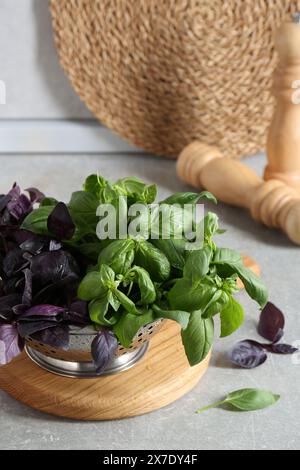 Metal colander with different fresh basil leaves on sink Stock Photo ...