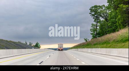 Semi-trailer of a truck with large tires viewed from side to rear on a ...