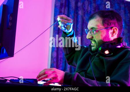 Streamer Angry computer gamer man yells and breaks keyboard after being ...