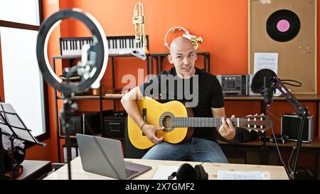 Young hispanic man musician having dj session at music studio Stock ...