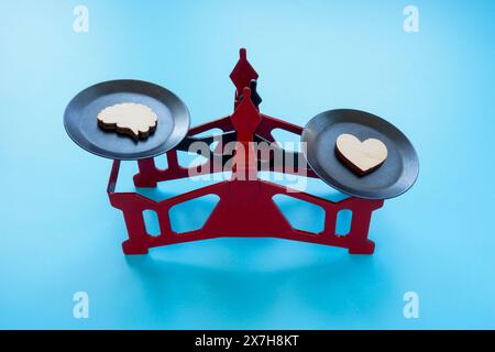 Emotional balance concept. Scales with brain and heart Stock Photo - Alamy