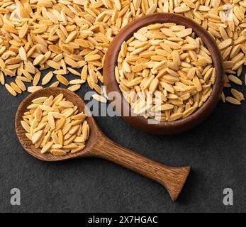 Organic semolina pasta is served in a small teal bowl with red ...