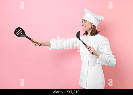 Professional chef with skimmer and ladle on pink background Stock Photo ...