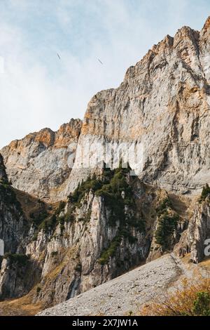 Two gliders soaring above the rocky cliffs of the Churfirsten mountain ...