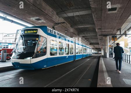 a tram pulls into Schiffbau light rail station, Zurich, underneath a ...