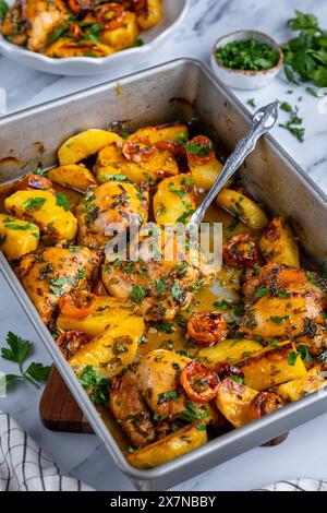 Baked chicken thighs with potatoes and spices Stock Photo - Alamy