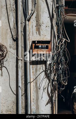 Old electrical wires in damaged plastic insulation, in mounting hole in ...