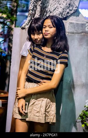Two young filipino girlfriends hug outside Santo Nino de Tondo Church ...