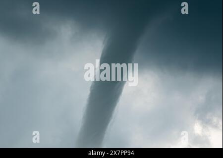 A tornado coming out of a supercell in Europe. A tornado is a violently ...