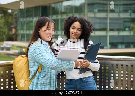 Students sharing notes in the university campus Stock Photo - Alamy
