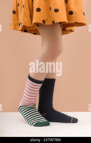 Odd socks day concept. Mismatch socks at blue Stock Photo - Alamy