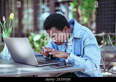 Woman looks intently at her laptop screen Stock Photo - Alamy