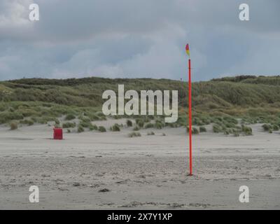 Germany, Lower Saxony, Juist, Flagpole in front of Memmertfeuer ...