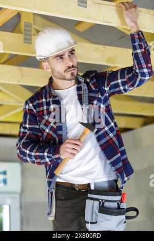 Carpenter, woodworker, strong builder on serious face carries wooden ...