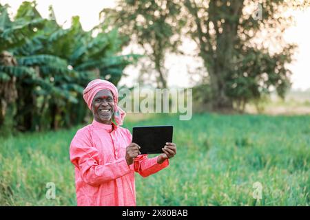 Indian farmer holding tablet Stock Photo - Alamy