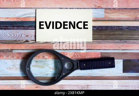 Word Evidence written on a yellow sticker Stock Photo - Alamy