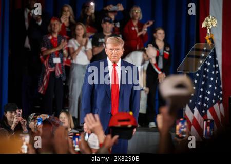 Donald Trump walks on stage with his mouth wide open at a campaign ...
