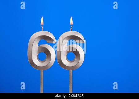 Lit birthday candle - Candle number 66 on white background Stock Photo ...