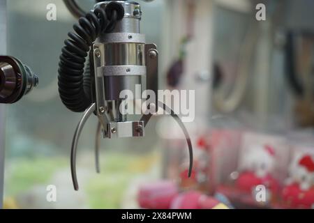 Claws for claw machines in the arcade Stock Photo - Alamy