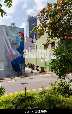 Vertical wall mural of a Samsui woman. a man jogging past the area ...