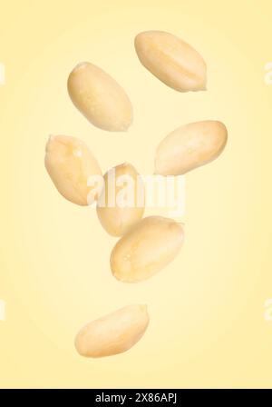 Many peanuts in air on white background Stock Photo - Alamy