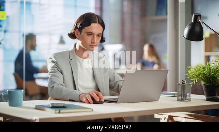 members of the business team sitting at Desk and looking at camera ...