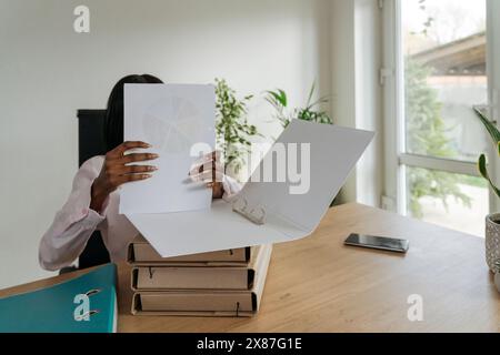 Woman with folder of documents at desk in office, closeup Stock Photo ...