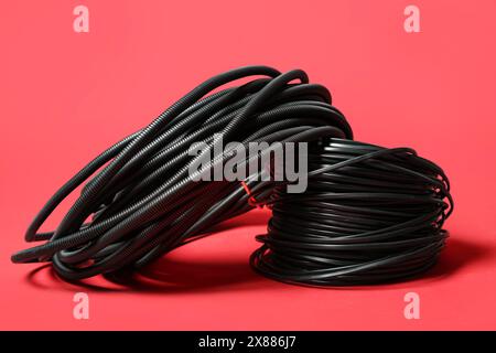 Rolled cables on red background, closeup Stock Photo - Alamy