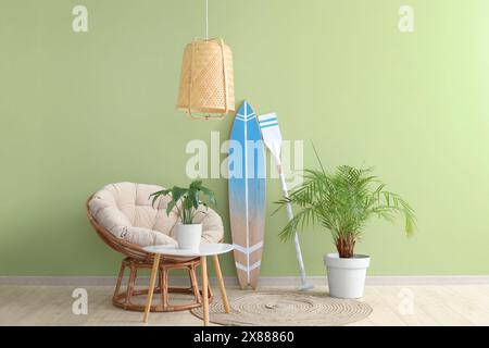 Interior of living room with surfboard, paddle and armchair Stock Photo ...