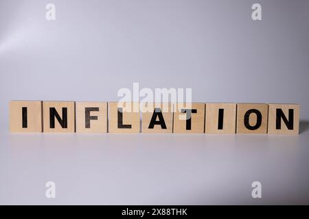 Yellow surface, with the word Inflation in black, underneath torn and ...