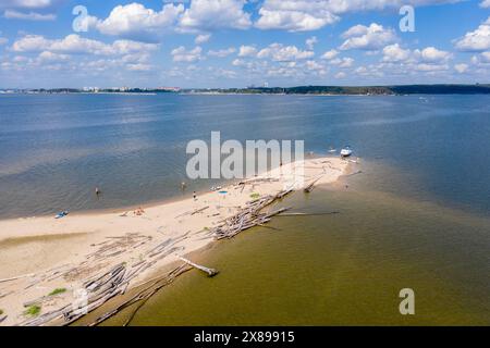 Aerial view of the sandy spit of an uninhabited island with a forest ...