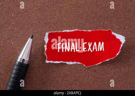 Final exam words written on ripped yellow paper with red background ...