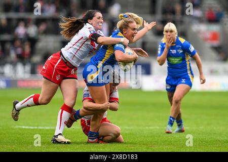 Lucy Murray of Leeds Rhinos has her hair pulled by Faye Gaskin of St ...