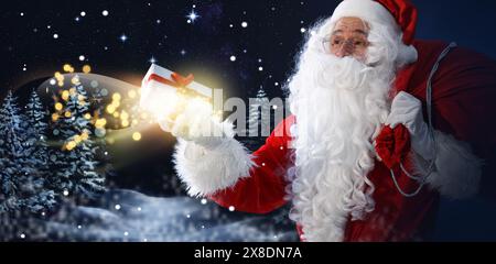 Banner. Santa Claus, in full costume, struggles to drag large Christmas ...