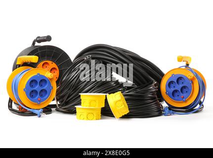 Rolled wires, flexible conduit tube and extension cable reels on white ...