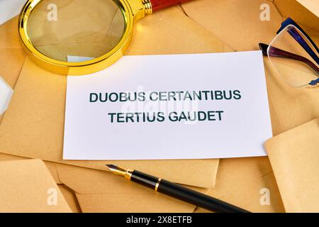 DUOBUS CERTANTIBUS TERTIUS GAUDET it means in Latin While two argue ...