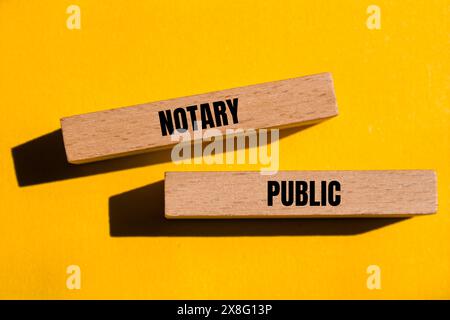 Notary public words written on wooden block with pink background ...