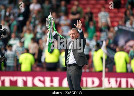 Celtic manager Brendan Rodgers lifts the trophy after winning the ...