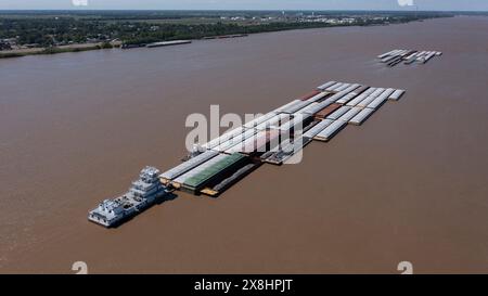 A towboat, known as a pusher, pushes barges full of cargo up the ...