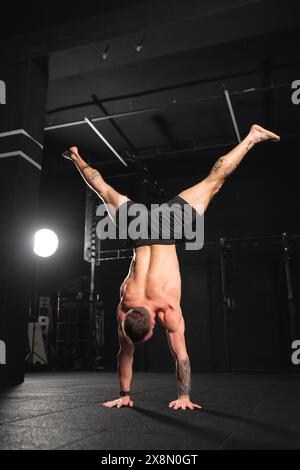 Rear view of handstand exercise, handstand push-ups. Routine workout ...
