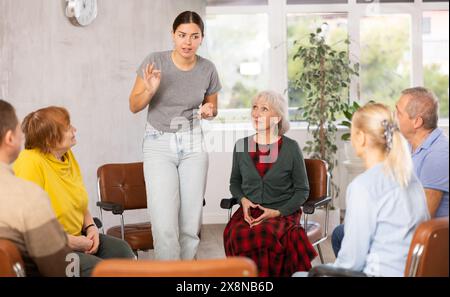 A young female teacher counseling students learning Stock Photo - Alamy