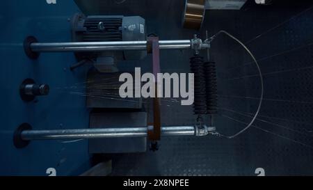 Coil winder machine with copper wire. Creative. Copper round rollers ...