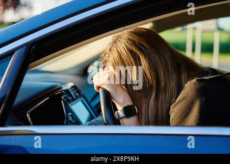 Woman feeling bored and frustrated while driving during her daily ...
