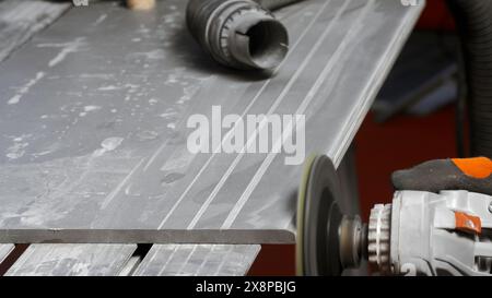 Process of grinding raw wood plank with angle grinder in workshop ...